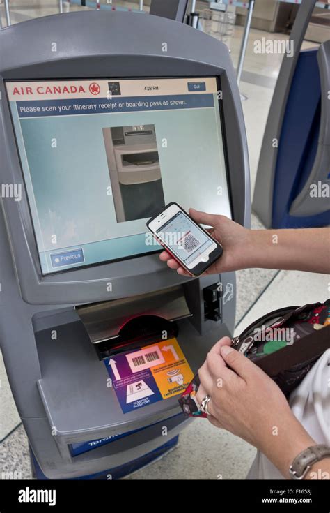 Woman Using Her Mobile Phone And Electronic Boarding Pass To Check In And Get Luggage Tags At