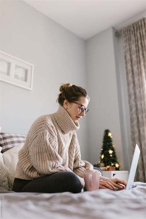 Woman Working With Computer At Bed By Stocksy Contributor Javier