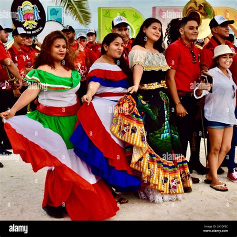 3 Ladies In Traditional Latin American Dresses Representing From Left