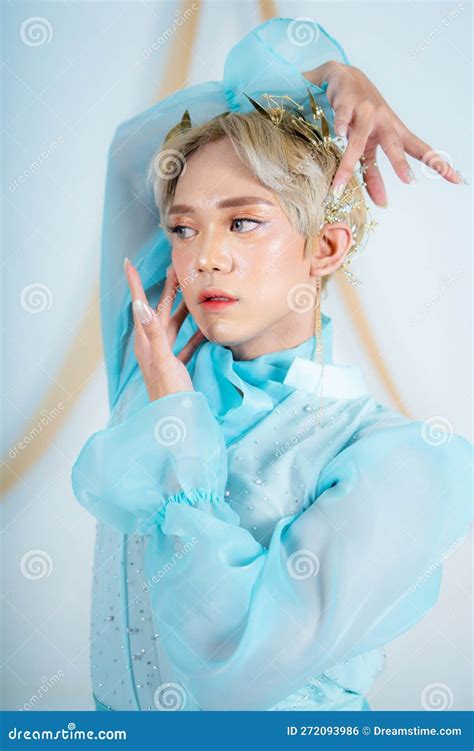 Beautiful Face Of An Asian Woman With Red Lipstick And Blue Eyes Stock