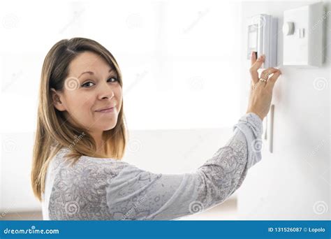 A Woman Set The Thermostat At House Stock Image Image Of Environmental Display