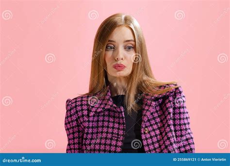 Portrait Of Young Beautiful Woman In Classical Suit Posing Over Pink