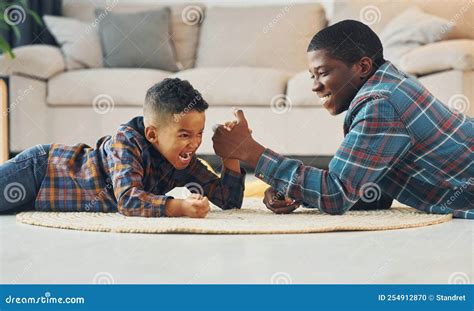 Side View African American Father With His Young Son At Home Stock