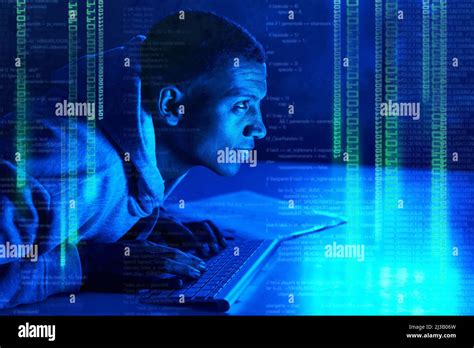 Hes A Menace In The Cyber World Shot Of A Young Male Hacker Cracking A