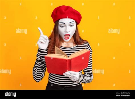 Portrait Of Cute Mime Woman Read Book And Finger Up Emotions And