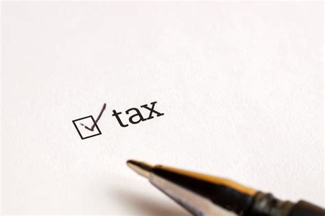 Premium Photo Checked Checkbox With Word Taxes And Dollars At