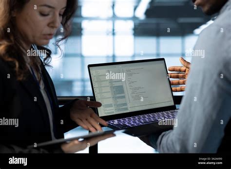 Software Developers In Data Center Workspace Use Laptop To Calibrate Energy Usage Server Room