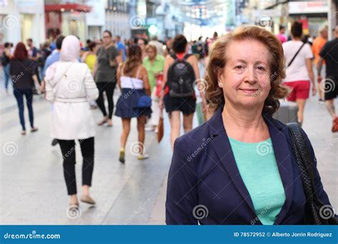 Attractive Mature Aged Woman Against Busy City Street With Lots Of