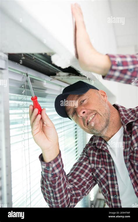 Happy Mature Fixing A Window Issue Stock Photo Alamy