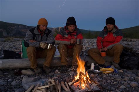Three Men Sitting Around A Campfire At License Image 70051317