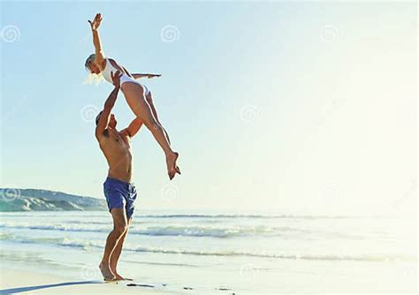 Summer Is Simply A Time For Endless Fun A Young Man Lifting His