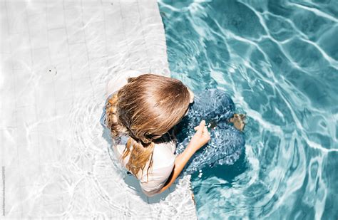 Young Woman Wearing All Her Clothes While Swimming In Pool During Night Time Spontaneous Summer