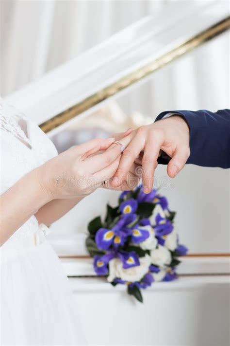 The Groom Places The Ring On The Brideand X27s Hand Photo Closeup Stock