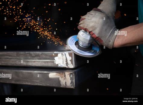 Metal Processing Grinder In Hand Worker Holds Tool Creation Of Steel