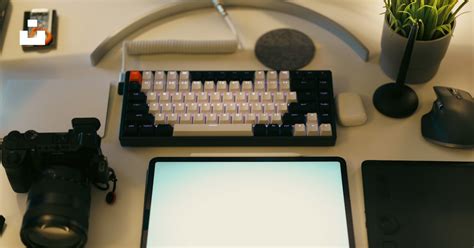 desk setup with digital camera keyboard and other accessories photo