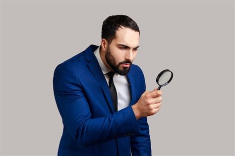 Premium Photo Curious Bearded Man Looking Through Magnifying Glass Finding Out Something