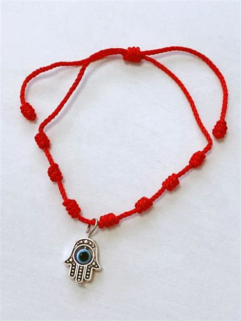 PULSERA 7 NUDOS ROJA CON MANO DE FÁTIMA Y OJO TURCO Mimada Consentida