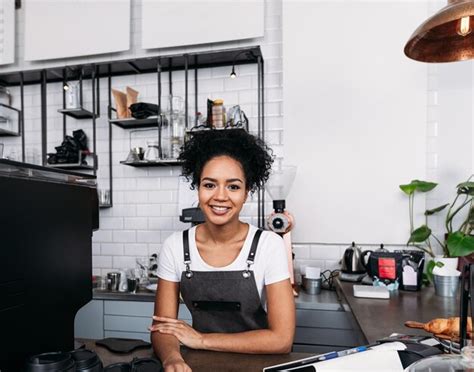 Premium Photo Waitress With Curly Hair In An Apron Standing At A