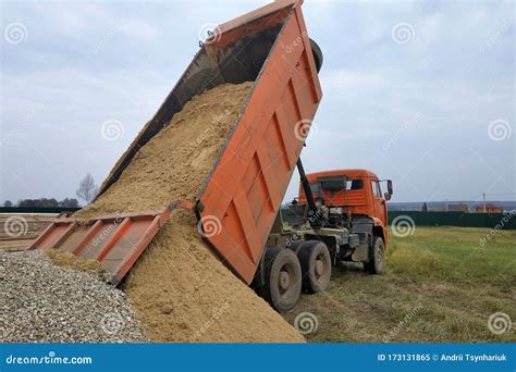 A Dump Truck Unloads Sand At A Construction Site Stock Image Image Of