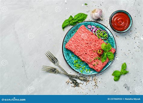 Raw Mince Beef Ground Meat With Herbs And Spices On A Plate Stock