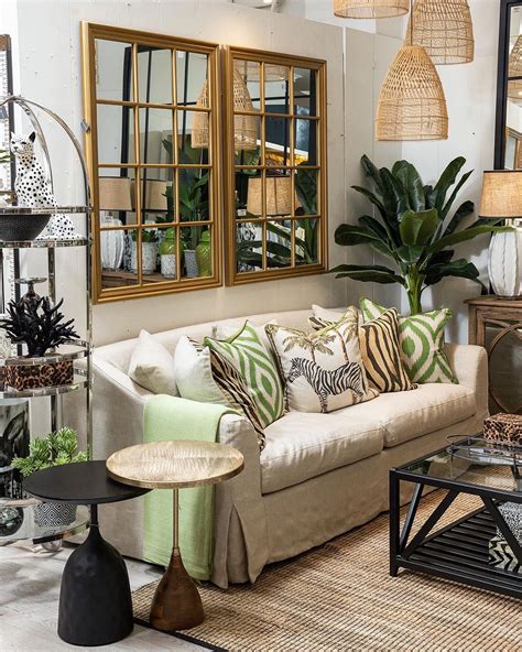 A Living Room Filled With Lots Of Furniture And Plants In Vases On Top
