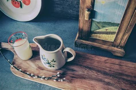 White Floral Ceramic Pitcher Beside Clear Drinking Glass Picture Image