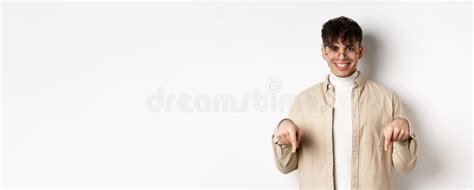Stylish Hipster Male Model In Glasses Pointing Fingers Down Smiling