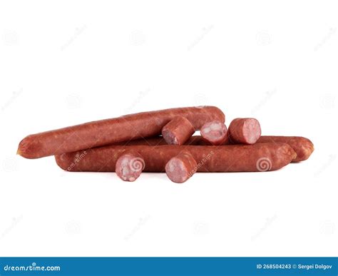 Several Whole Semi Smoked Sausages And Slices Of Thin Sausage On A