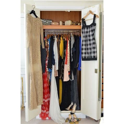An Open Closet Filled With Clothes And Shoes