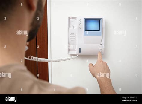 Man Pressing Button On Intercom Panel Indoors Closeup Stock Photo Alamy