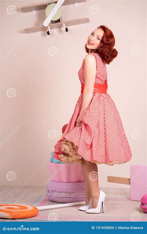 Beautiful Red Haired Pinup Smiling Happily Girl Posing In A Retro Red