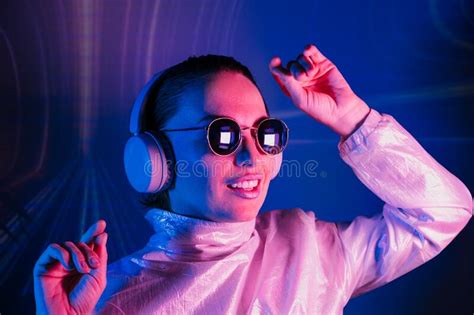 Portrait Of A Smiling Dancing Woman In Sunglasses And Headphones In