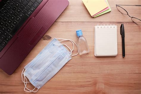Premium Photo Close Up Of Blue Surgical Masks And Hand Sanitizer On Table