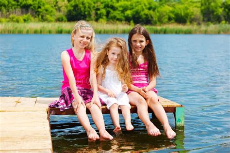 Three Barefoot Girls Sit And Look Into Distance Stock Image Image Of