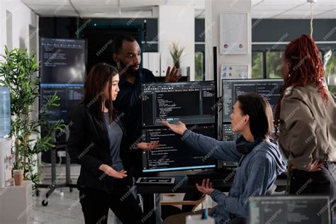 Premium Photo Multi Ethnic Web Developers Writing Script While Talking About Develop Cloud