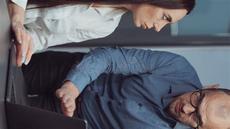 Vertical Screen Businesswoman Writing In Journal And Using Laptop