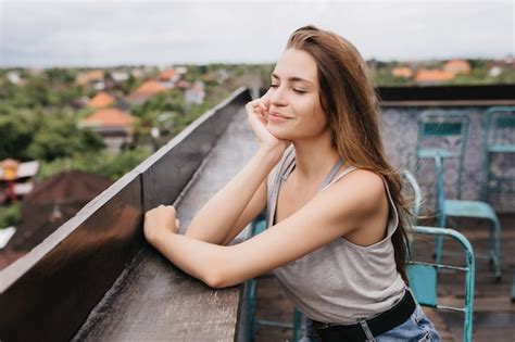 Free Photo Fascinating Young Woman Chilling At Roof With Eyes Closed
