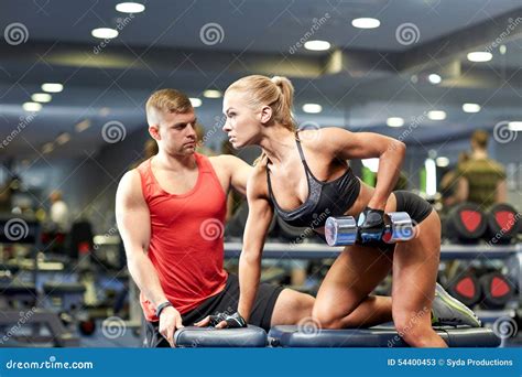 Young Couple With Dumbbell Flexing Muscles In Gym Stock Image Image