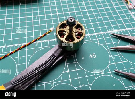 Fpv Drone Motor Is Mounted On The Arm Of A Drone Placed On A Table During The Assembly Process