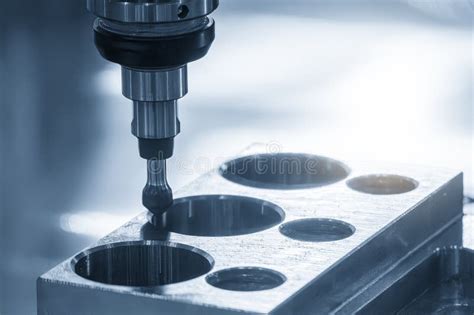 The CNC Milling Machine Chamfer Cutting Automotive Part In The Light Blue Scene Stock Photo