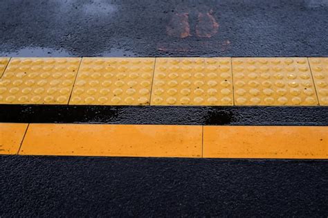 Premium Photo Yellow Pedestrian Path For The Disabled On Tiled Path