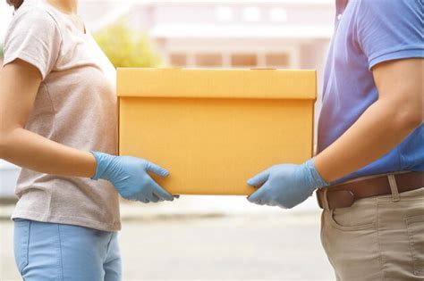 Premium Photo Parcel Delivery Man Of A Package Through A Service And