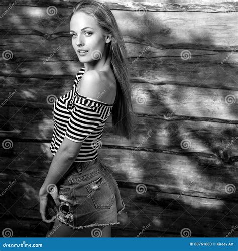 Young Sensual And Beauty Blonde Woman Pose On Wooden Background Black