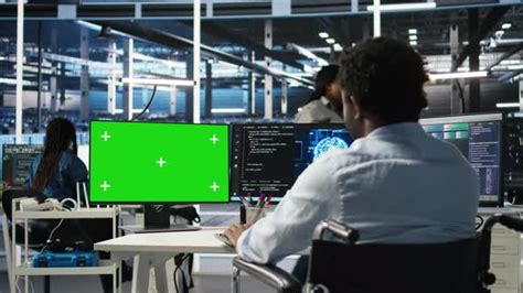 Data Center Admin In Wheelchair Using Ai Node Tree Software On Green Screen Pc Technology Stock