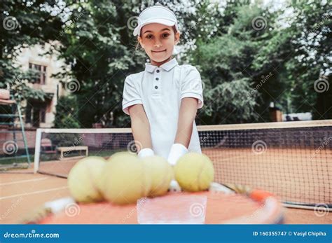 Girland X27s Hand Holds Tennis Racket With Yellow Balls On Tennis Court