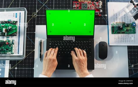 Anonymous Industrial Scientist Using Laptop Computer With Mock Up Green