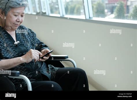 Elder Woman In Wheelchair Holding Mobile Phone Elderly Senior Female