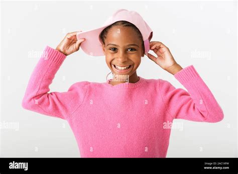 Image Of Cheerful African American Girl Smiling And Holding Pink Cap