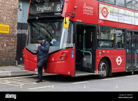 London Bus Driver Taking A Break Whilst Having A Vape As He Leans On
