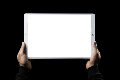 Hands Holding A Tablet Pc With White Screen Isolated On Black